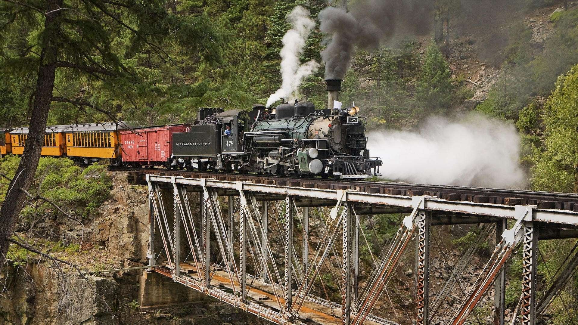 Historic Steam Train Crossing Scenic Mountain Bridge – HD Wallpaper