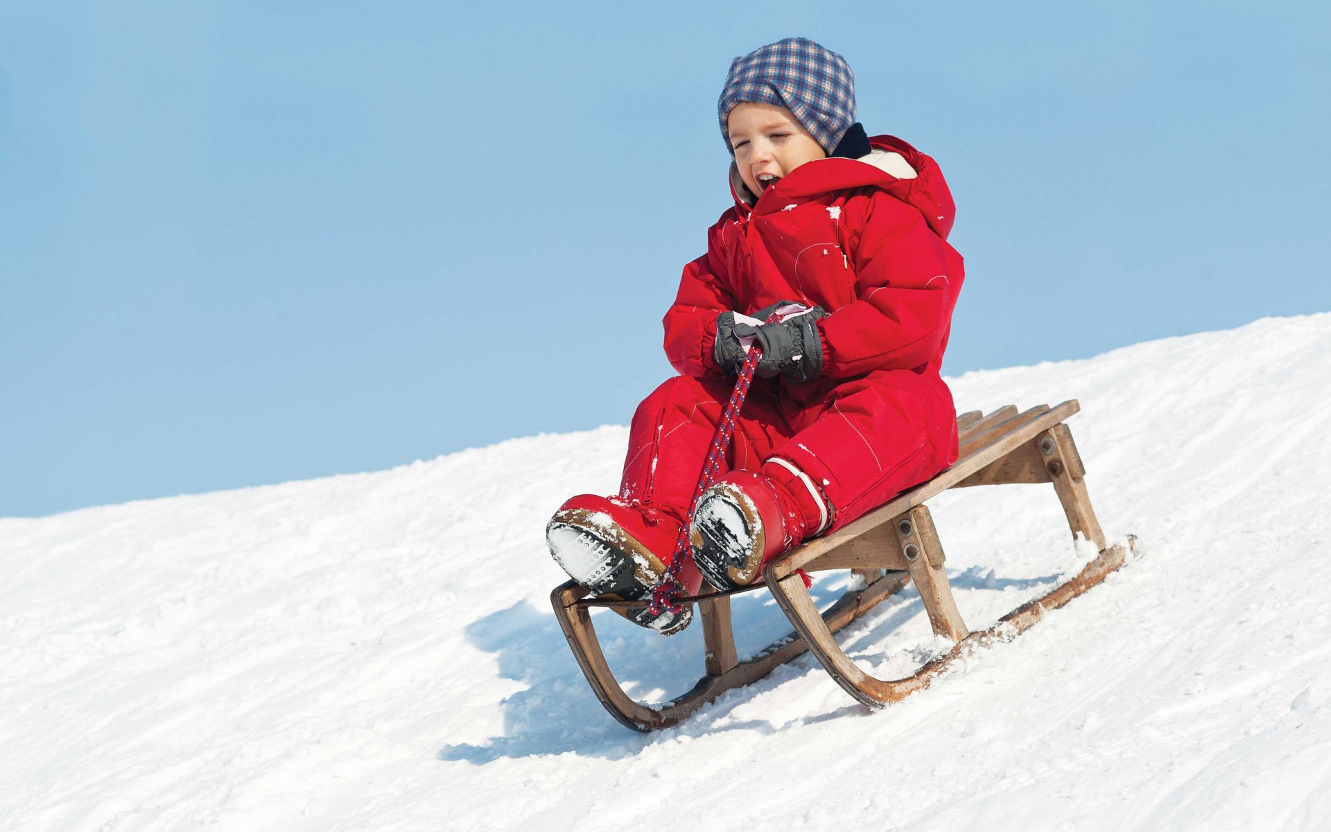 Joyful Winter Ride: HD Child Photography Wallpaper