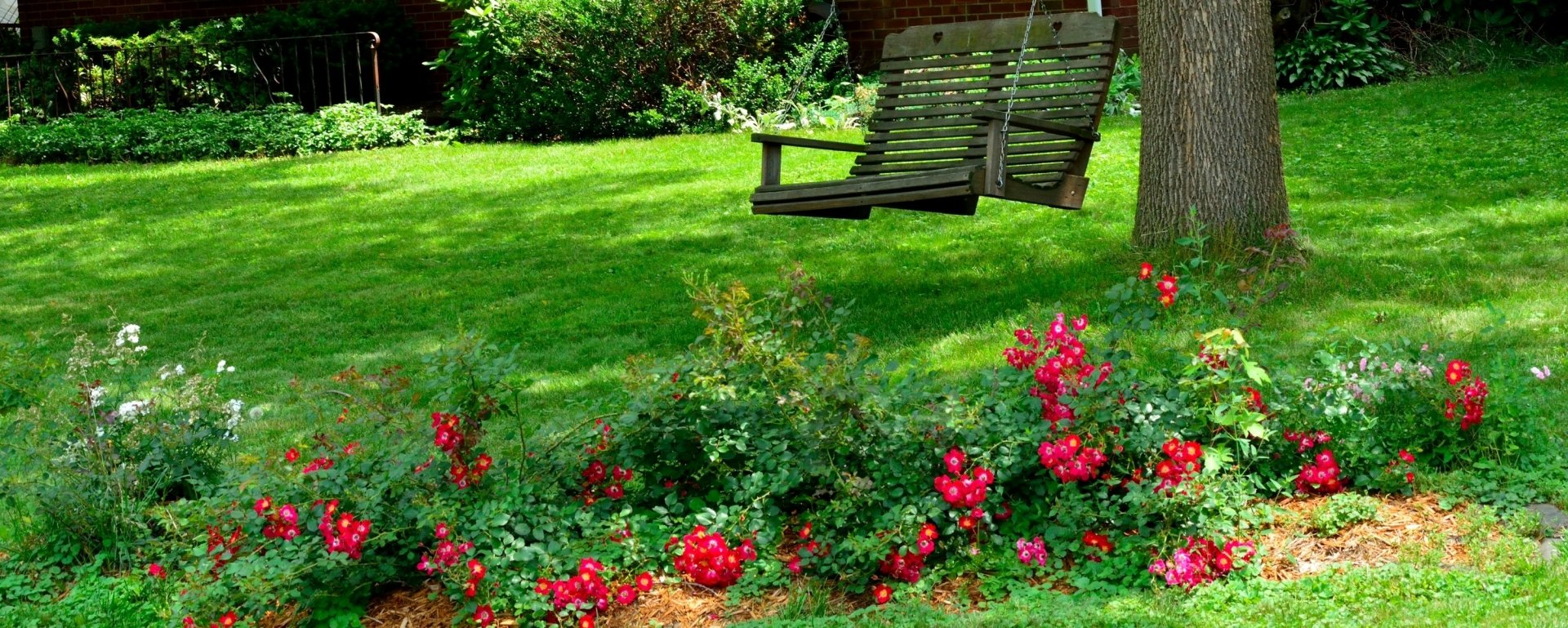 Spring Serenity: HD Wallpaper of a Flowered Swing in Nature