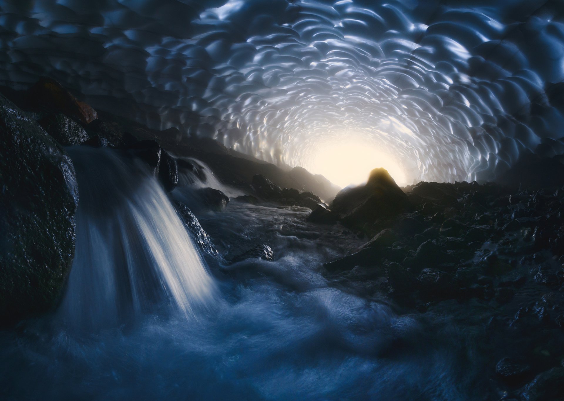 Frozen Stream Glow: A Stunning HD Ice Cave Nature Wallpaper