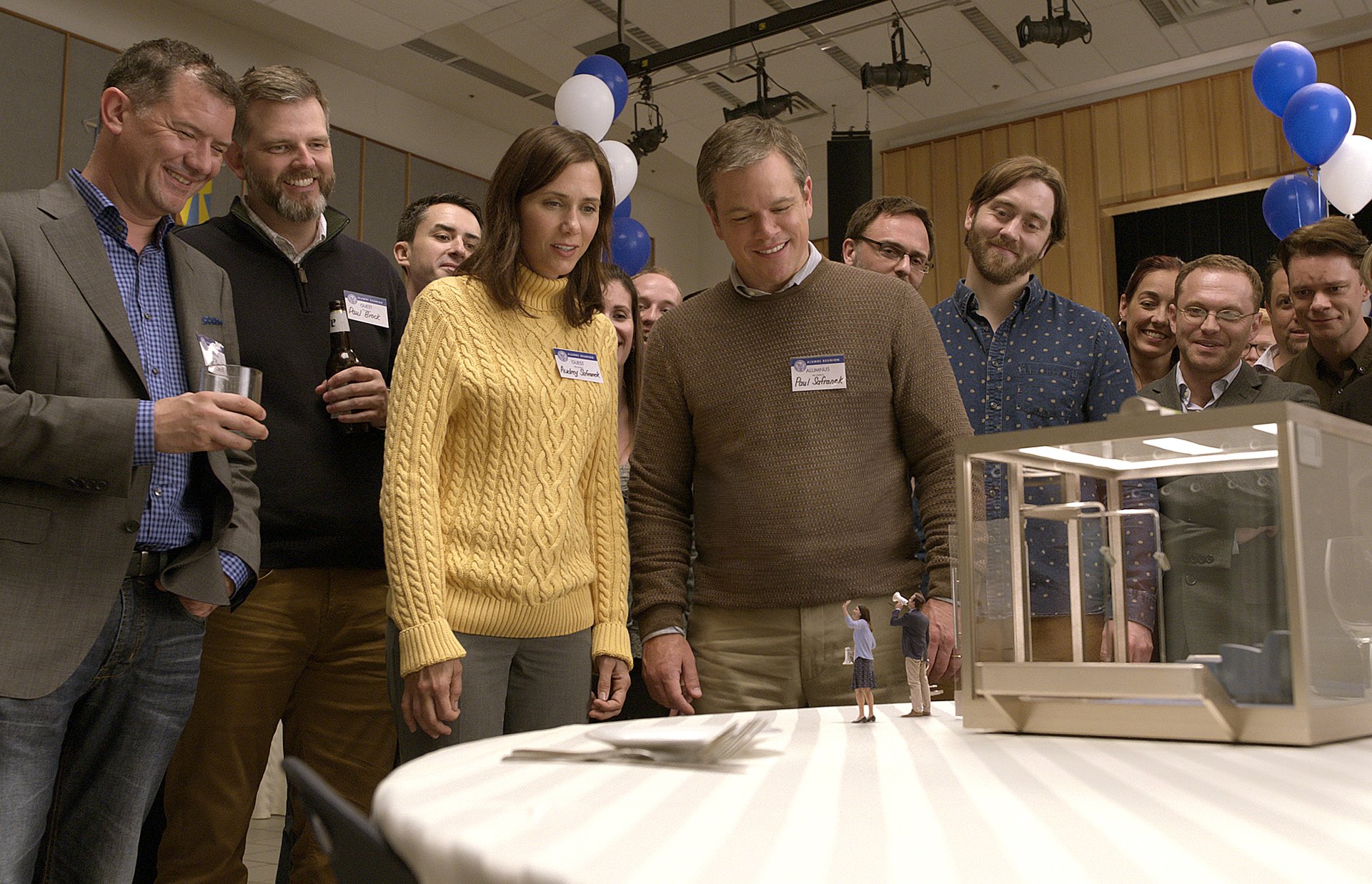 Downsizing Movie Scene HD Wallpaper - Group Gazing at Miniature Display